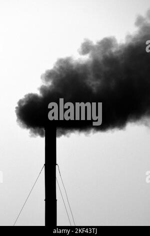 A grayscale shot of a factory emitting black toxic smoke Stock Photo ...