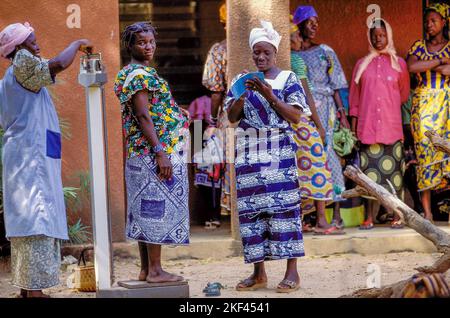 Burkina Faso, Piela. A pregnant woman is being weighed at a Tin Tua ...