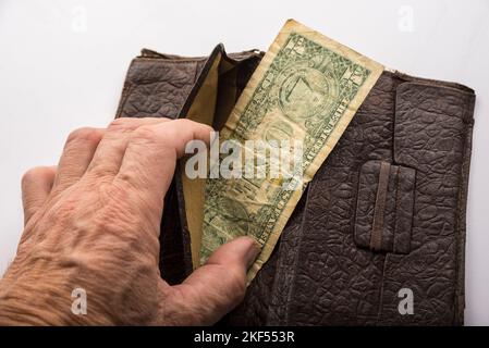 Poor pensioner torn wallet with one dollar Stock Photo - Alamy