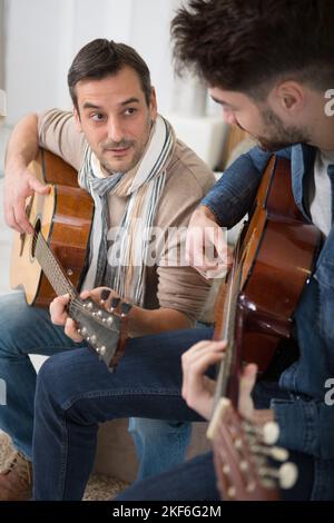 Teacher giving music lessons at school Stock Photo - Alamy