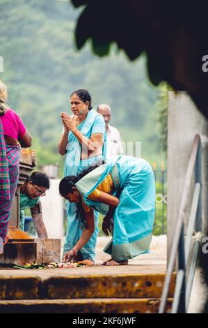 The women praying to idols and guards at the Narasimha Hindu temple in ...