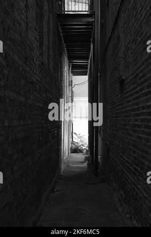 A typical common back alley between two urban buildings Stock Photo - Alamy