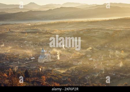 Dramatic autumn morning above the Ieud village in the historical region ...