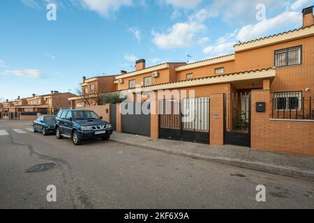 Facades of an urbanization of single-family homes one day with cloudy ...