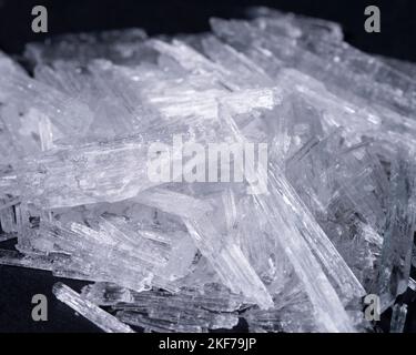 Menthol crystals on black background, closeup. Space for text Stock ...