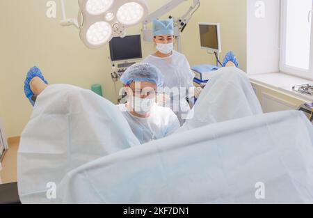 Doctor operating an endoscope to perform a colonoscopy examination ...