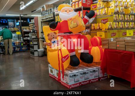 An inflatable Santa Claus decorates a Christmas tree sale in the ...