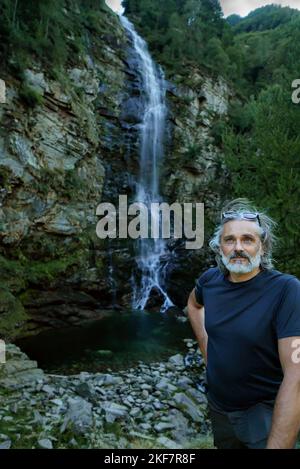 man under the Froda Waterfall in Sonogno, Switzerland Stock Photo - Alamy