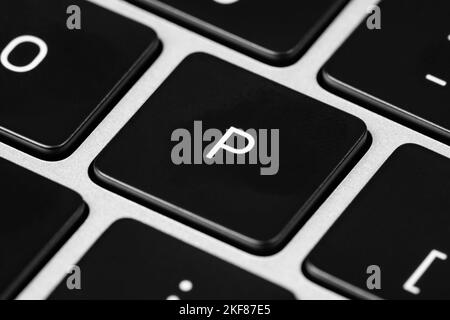 A closeup shot of a grey keyboard layout with black keys and white font ...