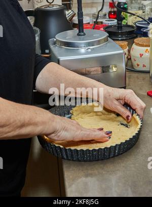 Girl in the kitchen kneads dough Stock Photo - Alamy
