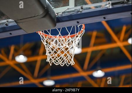 Indoor basketball basket net of white rope view from underneath against ...