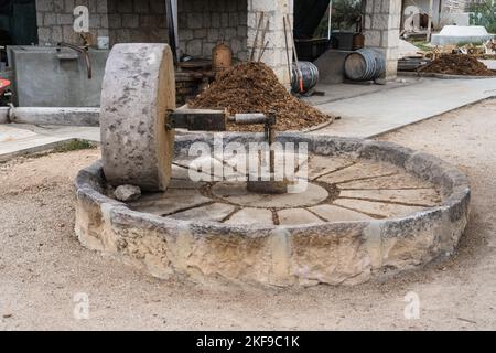 A large stone wheel for crushing the agave hearts after roasting them ...