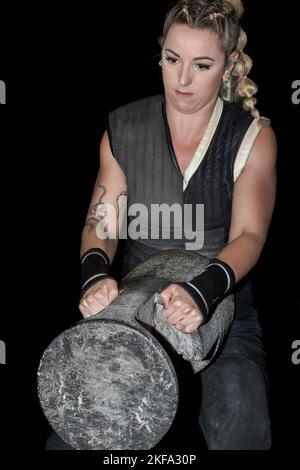 Basque stone that elevates the concept of rural sport. woman from the ...