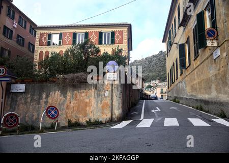 Narrow up hill street next to a wall on a cloudy day Stock Photo - Alamy