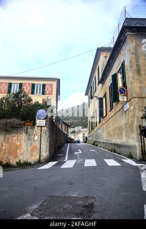 Narrow up hill street next to a wall on a cloudy day Stock Photo - Alamy