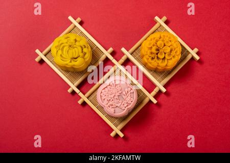 trendy flower shape mooncake on red background Stock Photo - Alamy