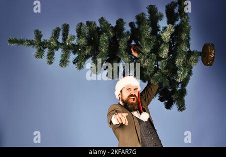 Businessman with raging face holds bald Christmas tree up Stock Photo ...