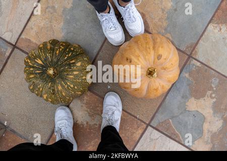unrecognizable two people feet with white tennis shoes next to two ...