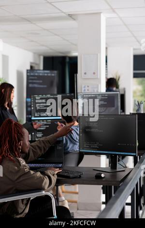 Software developer wheelchair user working on html script code, checking database and server to ...