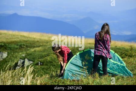 Teamwork concept. Attach necessary structural components tent. Almost ...
