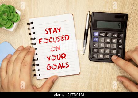 Inspirational quote - Stay focused on your goals. With text message on ...