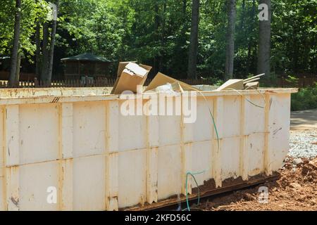Construction site rubbish removal metal container on recycle garbage ...
