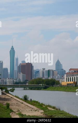 The Sheung Yu River in Lo Wu, Hong Kong with tall buildings in Shenzhen ...