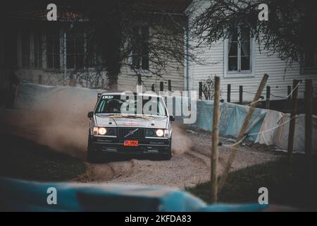 A vintage racing car surrounded by dust and smoke at the Zabra Rally in ...