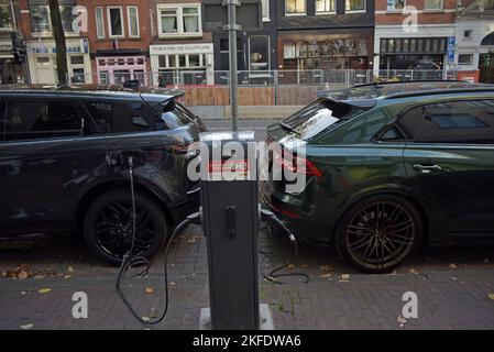 EV electric Range rover and Audi cars charging at an on street charging ...
