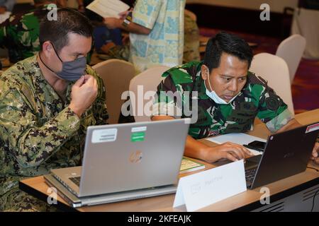 US Navy Lt. Cmdr. review medical care charts Stock Photo - Alamy
