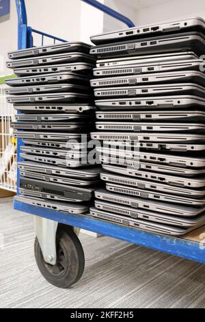 Big stacks of discarded laptops, notebooks on a trolley Stock Photo - Alamy