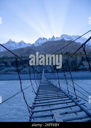 Landscape view of Hussaini suspension bridge above Hunza river with ...