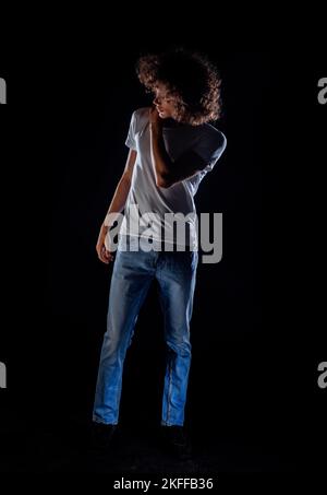 Body shot of an attractive male punk model posing isolated on black ...