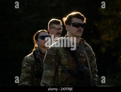 Airmen assigned to the 673rd Security Forces Squadron operate and fire ...