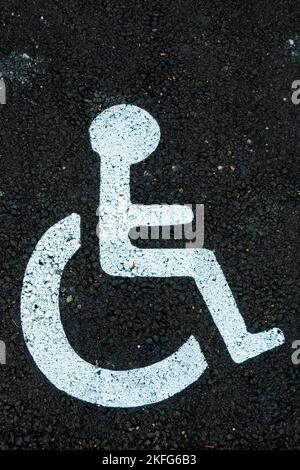 Disability accessibility symbol painted on pavement in a public area ...