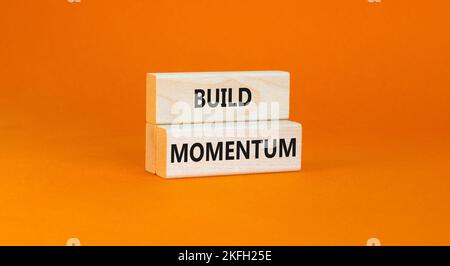Build momentum symbol. Concept words Build momentum on wooden blocks ...