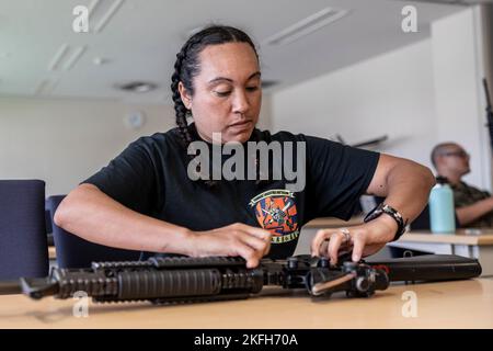Sandra Lerma, a military spouse, disassembles an M16A4 service rifle ...