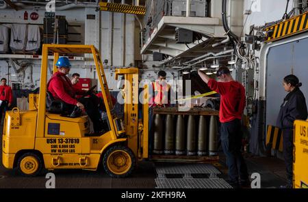 220916-N-DP708-1633 Sailors use a forklift to transport a palette to an ...