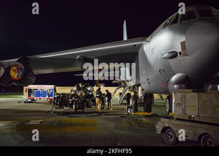 Airmen from the 705th Munitions Squadron load a B-52H Stratofortress ...
