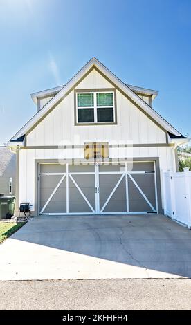 The rear back side of a long cottage style new construction cream white ...
