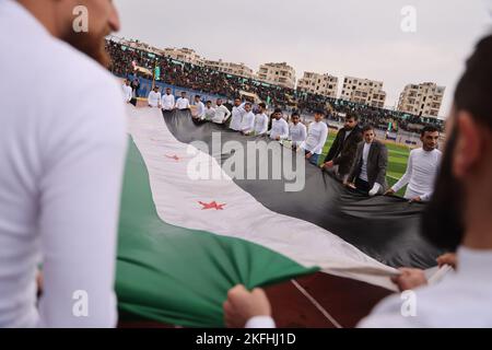 Idlib, Syria. 18th Nov, 2022. People hold a giant flag during the ...