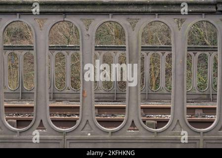 Metal railway bridge with oval openings. Patterned background with ...