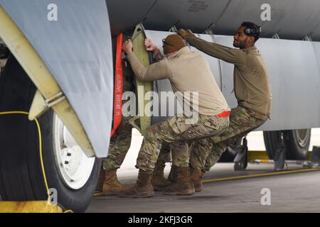Maintenance Airmen with the 5th Bomb Wing hold the bomb bay doors of a ...