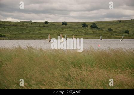 windsurfers at clowbridge reservoir. bright yellow and green sails ...