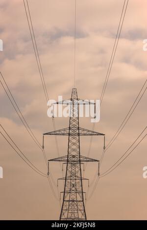 Symmetrical patterns on the electricity pylon. Cloudy blue and white ...