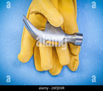 Composition of claw hammer protective gloves on blue background ...