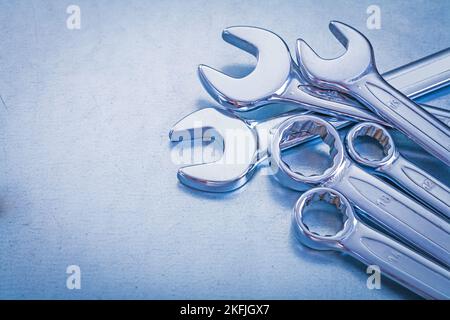 Steel open-end wrenches and flat spanners on metallic background ...