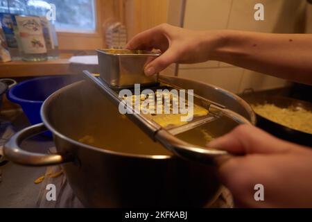 A female grating butter into the boiling water Stock Photo - Alamy
