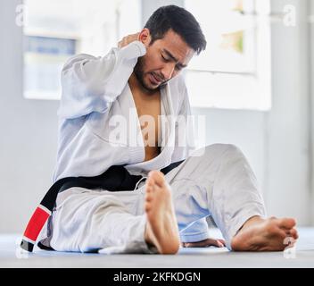 Karate, sports and neck injury pain of fighter on floor with surrender ...