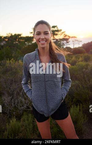 Portrait of a young beautiful female runner concentrating before ...